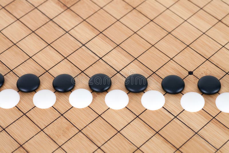 Two Rows of Go Pieces on the Chessboard Stock Image - Image of ...