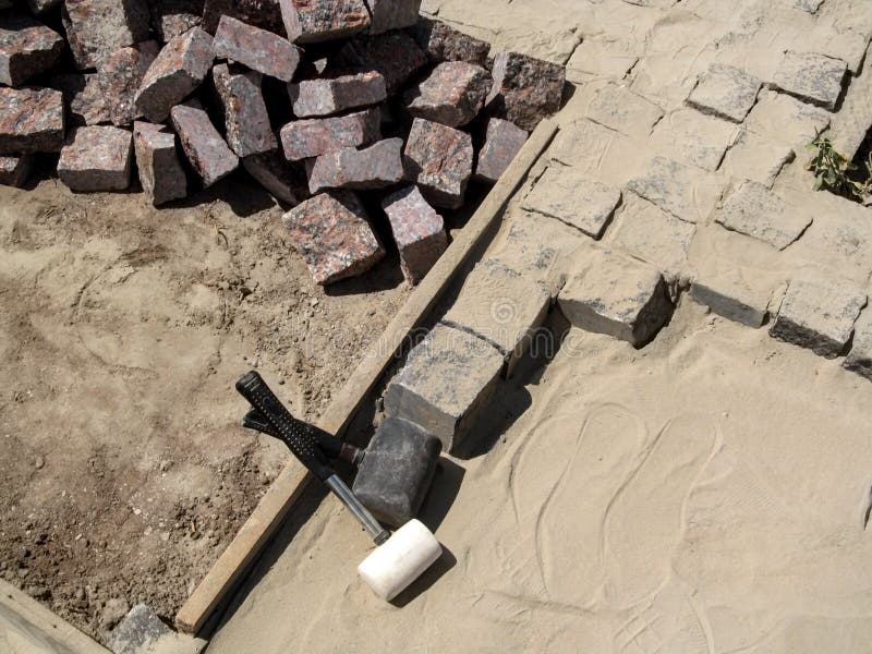Two Rubber Mallets among a Pile of Granite Stones for Paving Stock ...