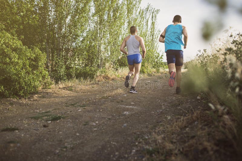 Two Runners Running Outdoors Stock Image - Image of back, young: 176540917