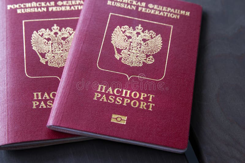 Two Russian Passports in Hand. Russian Official Document on Wooden ...