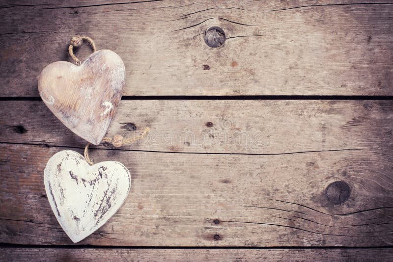 Two Rustic Decorative Hearts on Vintage Wooden Background Stock Image ...