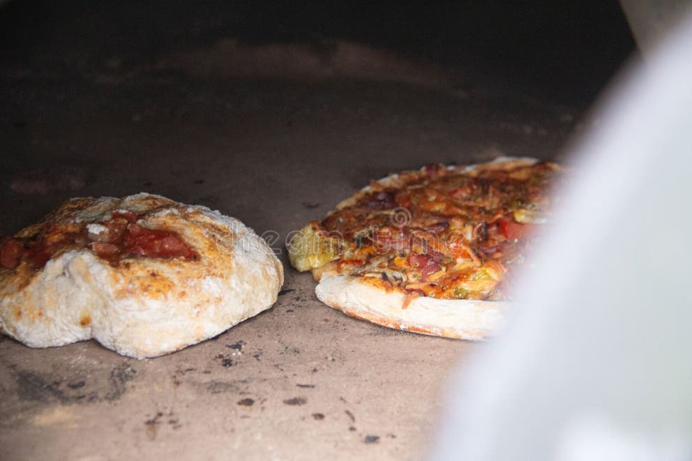 Two Rustic Pizzas Baking Inside a Traditional Stone Oven with Rising ...
