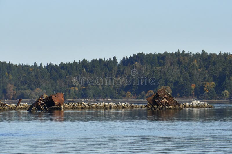 Two Rusty Derelict Navy Ship Hulls on an Ocean Breakwater that Formerly ...
