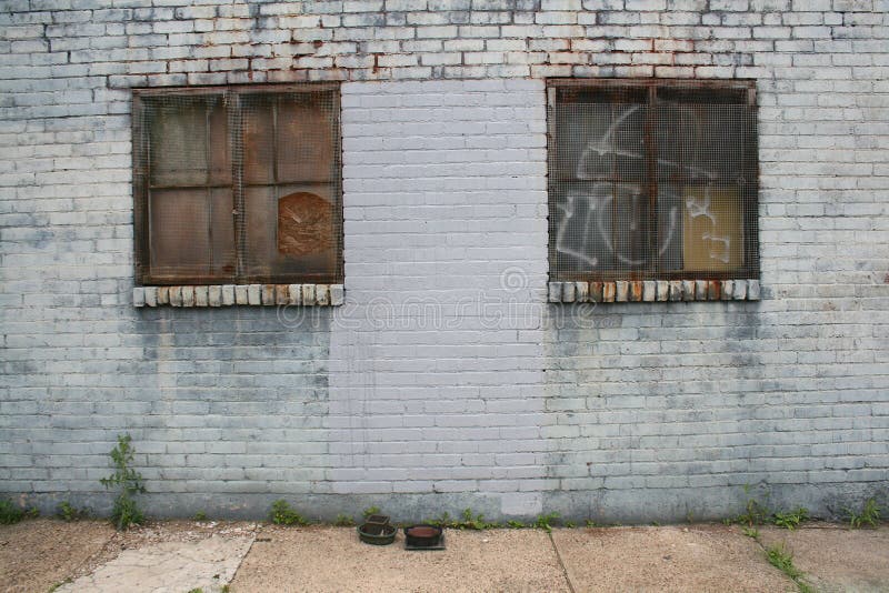 Two Rusty Metal Windows on Painted Brick Wall Stock Photo - Image of ...