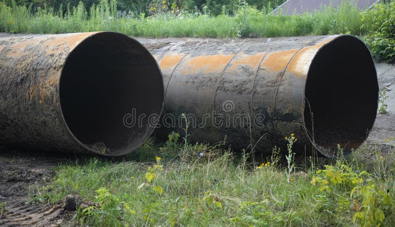 Two Rusty Old Pipes Laying on Grass Stock Photo - Image of metal, green ...