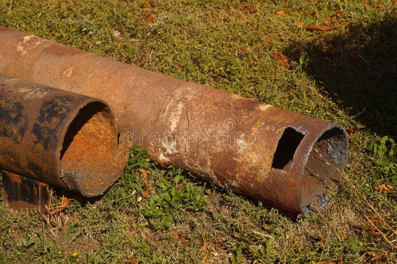 Two Rusty Old Pipes Lying on Grass Stock Image - Image of lying, rusty ...