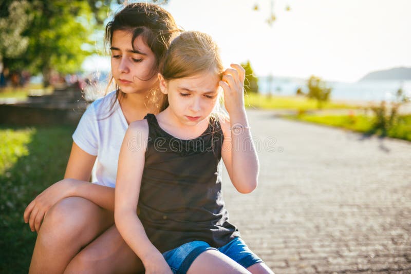 Two Sad Girls Sitting on a Bench in Park Stock Image - Image of lost ...