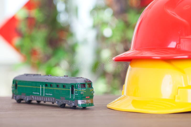 Two Safety Helmets and a Model Green Train on the Table Stock Photo ...