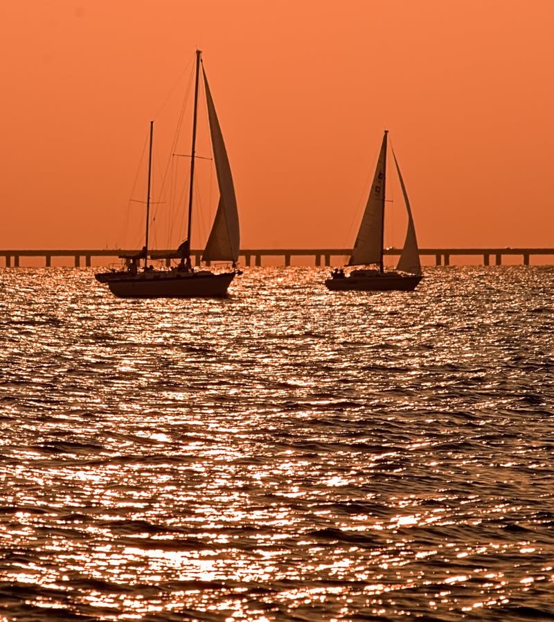Two sailboats at dusk stock photo. Image of dusk, glowing - 10567202