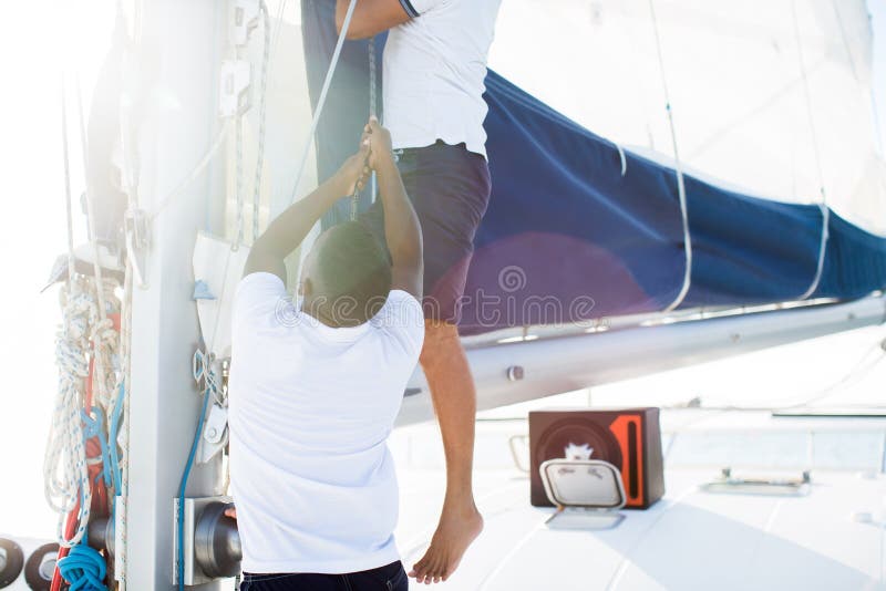 Two Sailors Discover a Sail on a Yacht. Editorial Stock Image - Image ...
