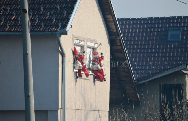 Santa Claus Dolls are Hanging in the Window Stock Photo - Image of wall ...