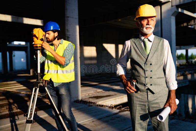 Two Satisfied Engineers Talking at Building Site with Construction ...
