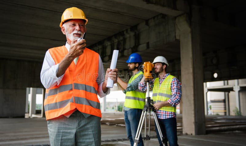 Two Satisfied Engineers Talking at Building Site with Construction ...