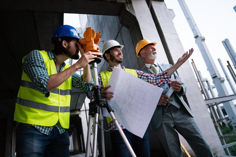 Two Satisfied Engineers Talking at Building Site with Construction ...