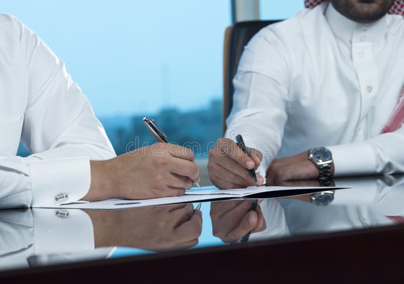 Two Saudi Businessmen Hands Signing a Ducument Stock Photo - Image of ...