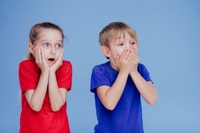Two Scared Children with Hands on Face Isolated on Blue Stock Image ...