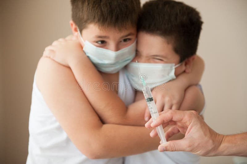 Two Scared Children in Medical Mask Looking at Hand with Syringe Stock ...