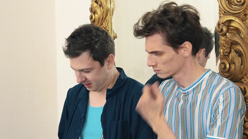 Two Scared Men Sits in White Hall at Mirror Arguing Stock Footage ...