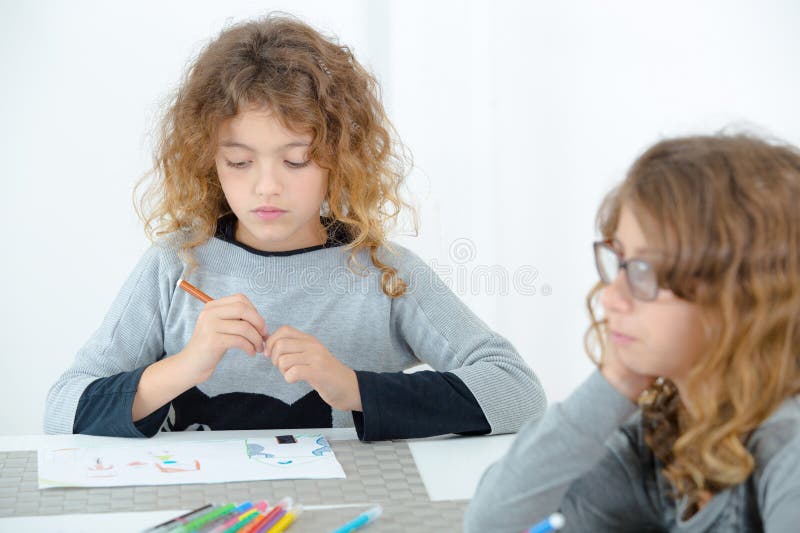 Two School Aged Girls Sat at Table Drawing Pictures Stock Image - Image ...