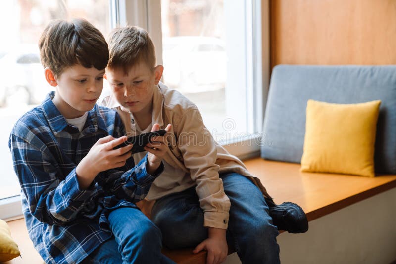 Two Boys Using Mobile Phone while Sitting in Classroom Stock Image ...