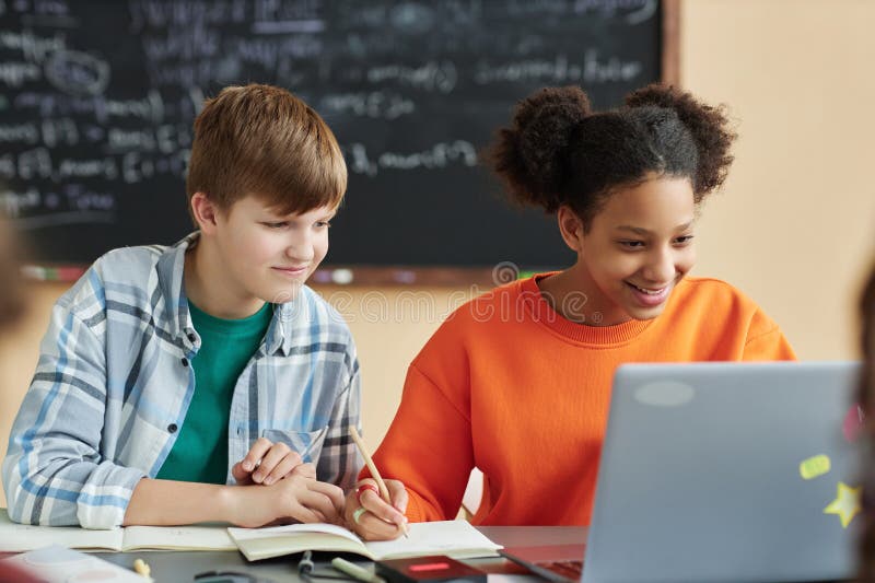 Two School Children Using Laptop Computer in Class Stock Photo - Image ...
