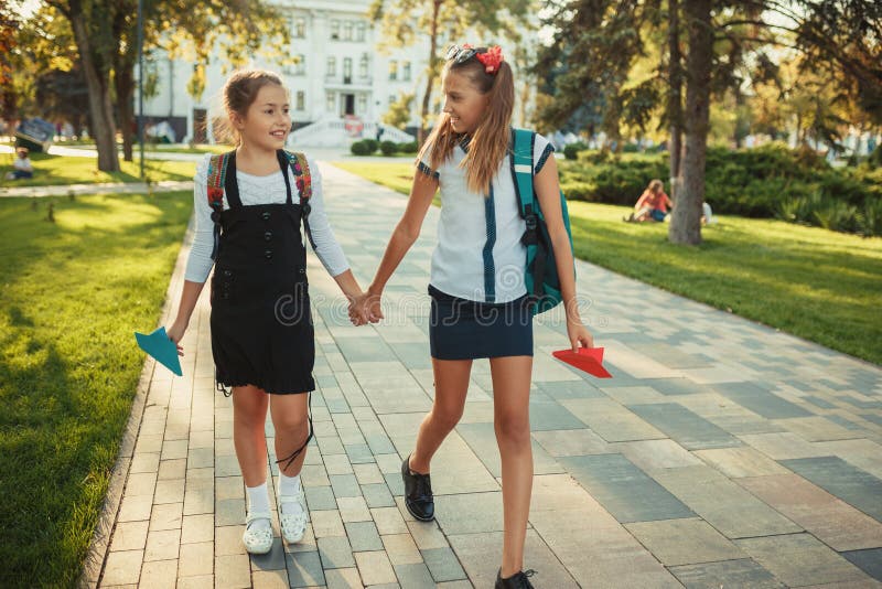 Two School Friends Walk after Classes in a Park Near the School Stock ...