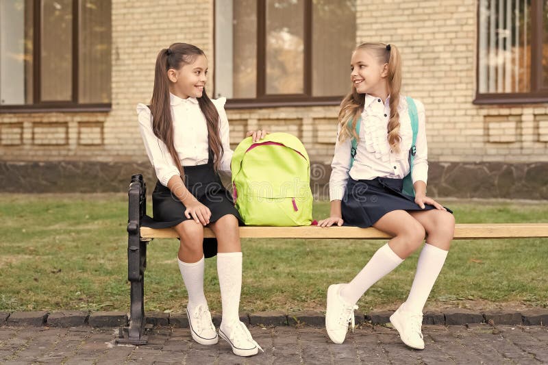 Two School Girls Friends Sit on Bench with Backpack Together Stock ...