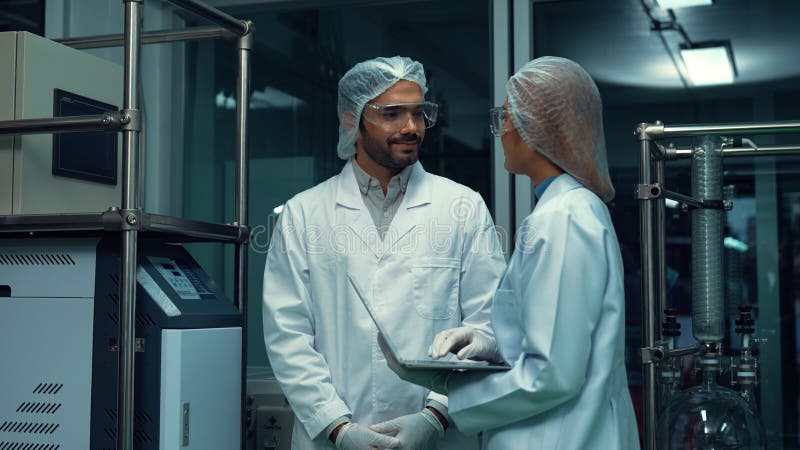 Two Scientist in Professional Uniform Working in Laboratory Stock Photo ...
