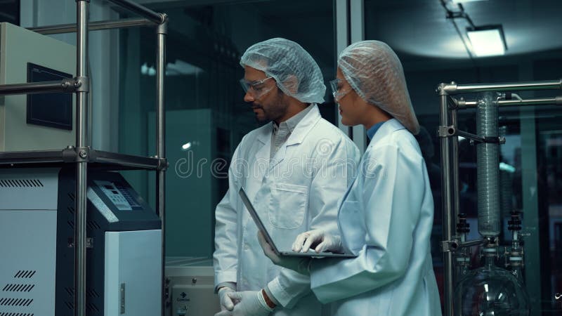 Two Scientist in Professional Uniform Working in Laboratory Stock Photo ...