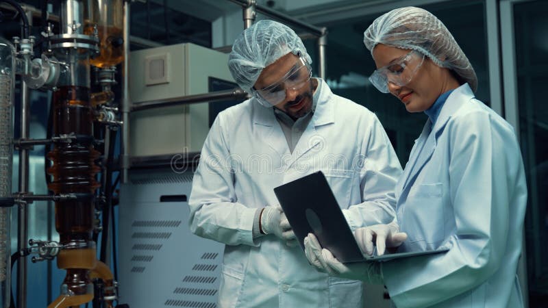 Two Scientist in Professional Uniform Working in Laboratory Stock Photo ...