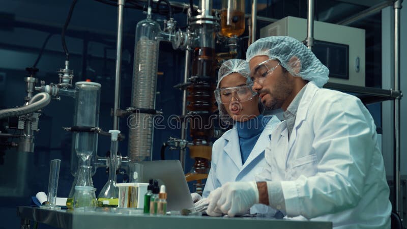 Two Scientist in Professional Uniform Working in Laboratory Stock Photo ...