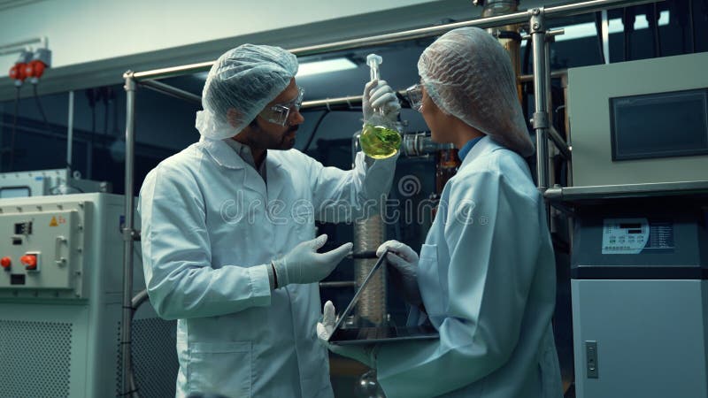 Two Scientist in Professional Uniform Working in Laboratory Stock Photo ...