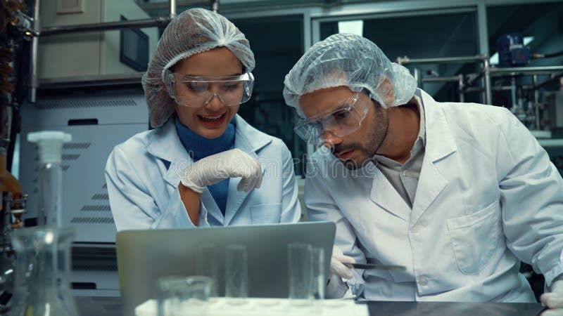 Two Scientist in Professional Uniform Working in Laboratory Stock Photo ...