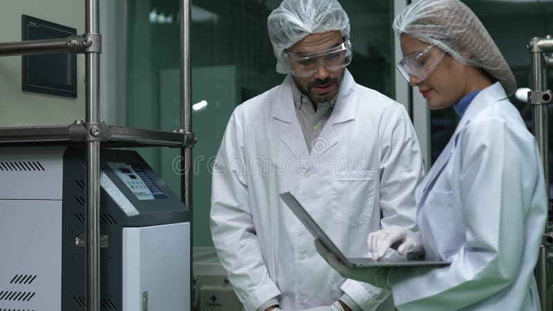 Two Scientist in Professional Uniform Working in Laboratory Stock Photo ...