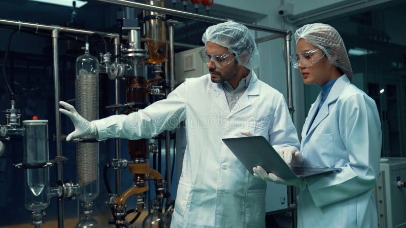 Two Scientist in Professional Uniform Working in Laboratory Stock Photo ...