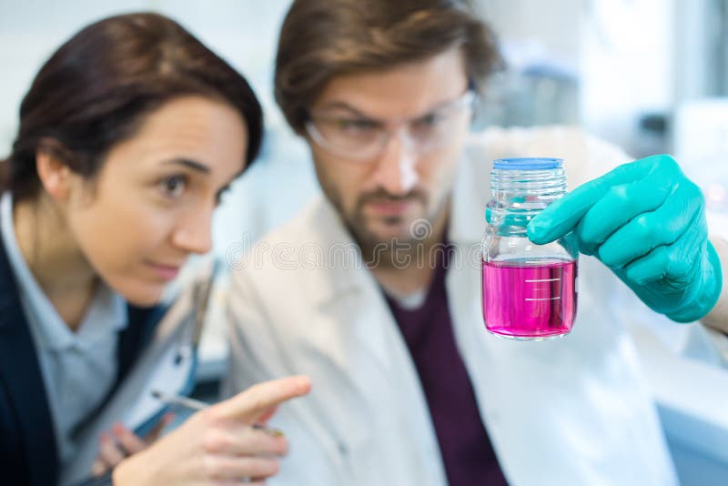 Two Scientists Doing Experiments with Chemical Liquid in Lab Stock Image - Image of science ...