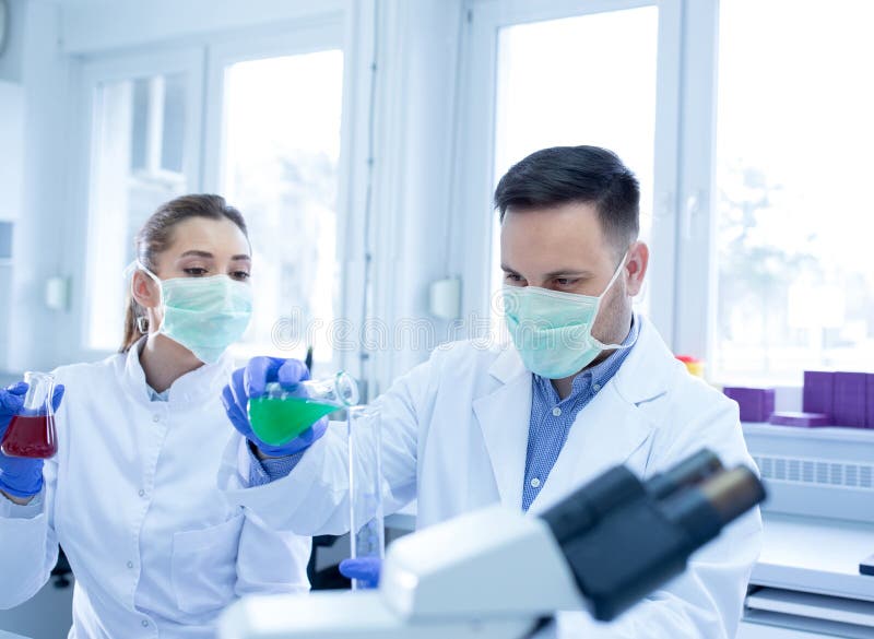 Two Scientists Doing Experiments Using Erlenmeyer Flask and Lab ...