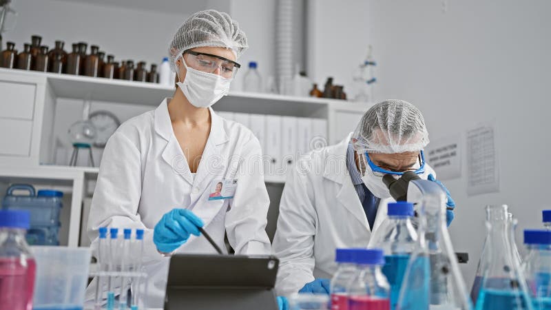 Two Scientists, in Full Medical Gear, Analyzing Covid19 Samples at the ...