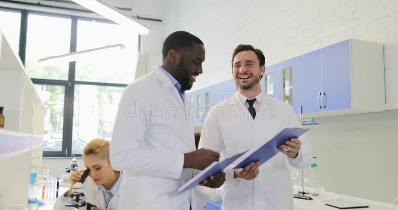 Cheering Scientists in Hazmat Suit Dancing and Having Fun at Work in ...