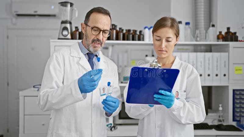 Two Scientists Holding Test Tube Taking Notes at Laboratory Stock Photo ...