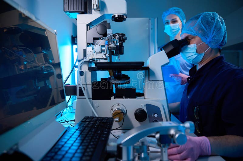 Two Embryologists Working with a Micro-manipulation System Stock Image ...