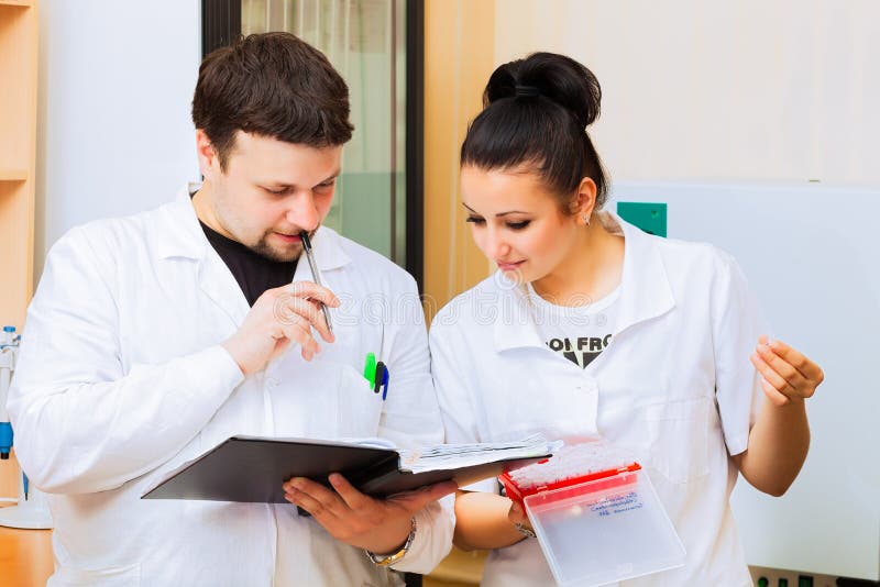 Two Scientists with Lab Journal Stock Image - Image of research ...