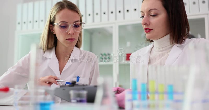 Two Scientists in a Laboratory are Conducting Experiment and Research ...