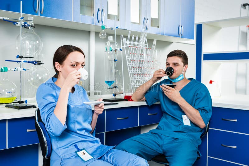 Two Scientists in Uniform Drinking a Coffee after Some Research Stock ...