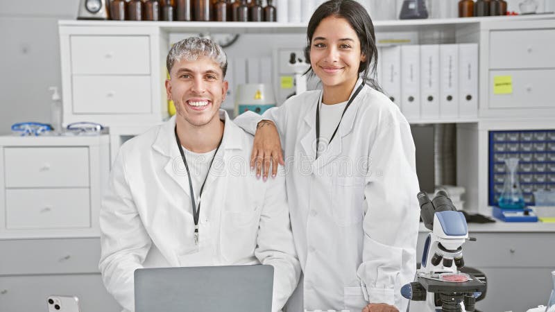 Two Scientists, a Woman and a Man, Smiling in a Laboratory with a ...