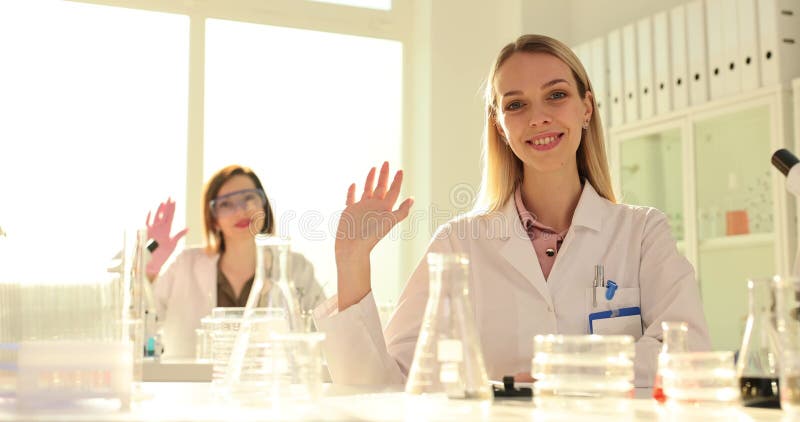 Two Scientists Work in a Laboratory and Wave at Camera Stock Video ...