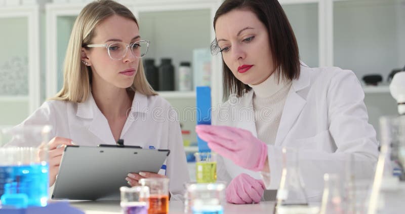 Two Scientists Working in Laboratory are Conducting an Experiment Stock ...