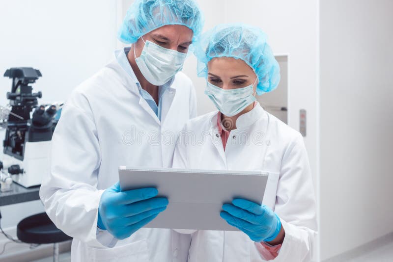 Two Scientists Working Together in Lab Looking at Data Stock Photo ...