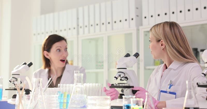 Two Scientists Working Together in a Laboratory Make a Discovery and ...