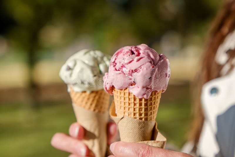 Two Scoops of Ice Cream in Hand. Ice Cream on a Summer Day Outdoors ...